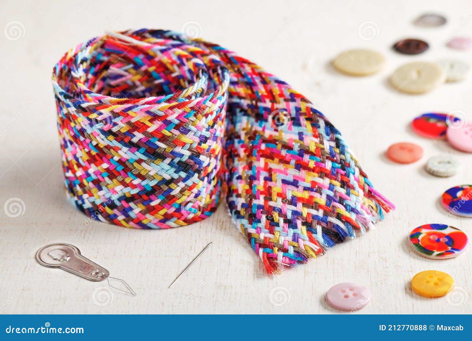 A Braid of Multi Colored Sewing Threads, Needle, Needle Threader ...
