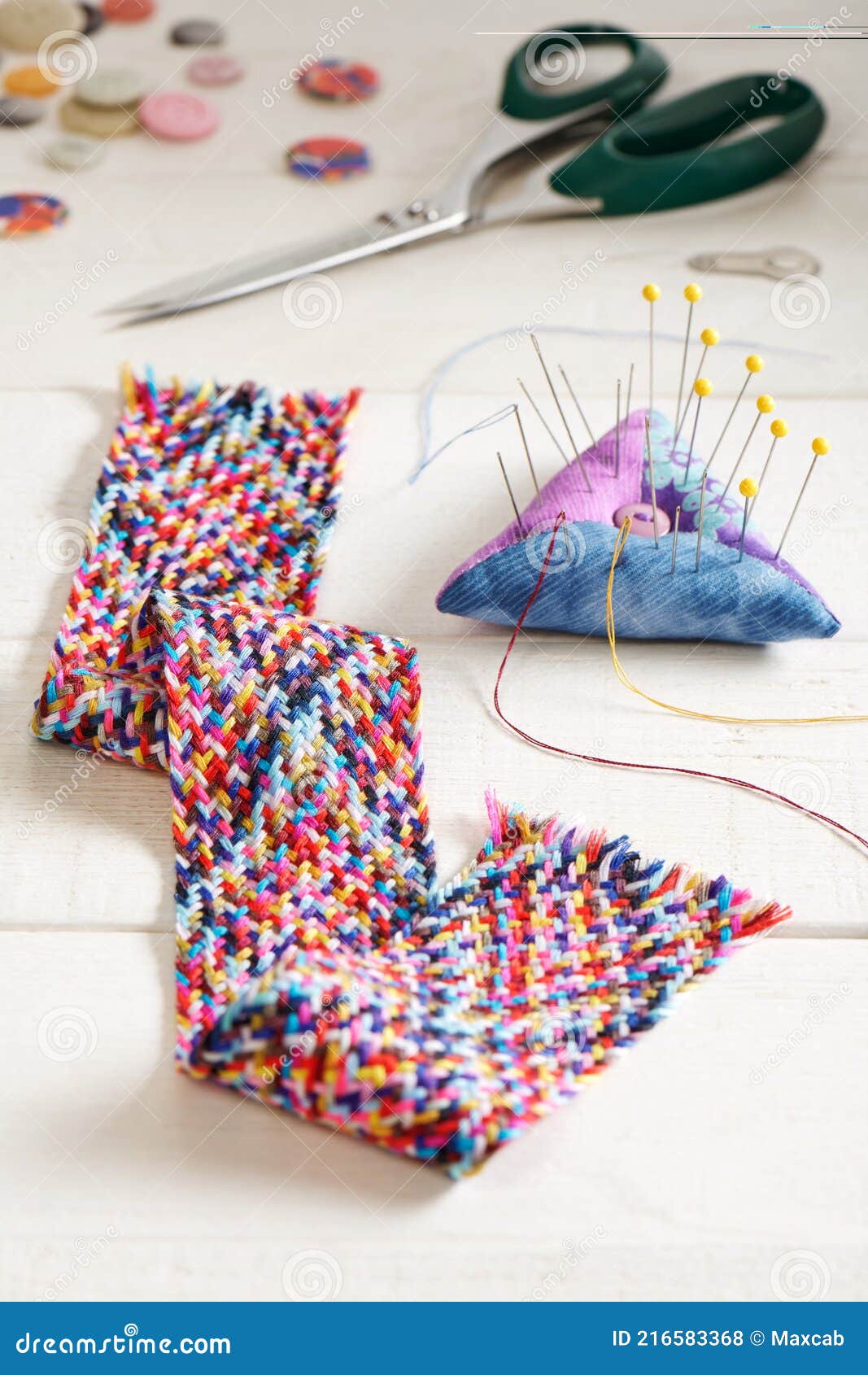 A Braid of Multi Colored Sewing Threads, Pincushion, Scissors, Needle ...
