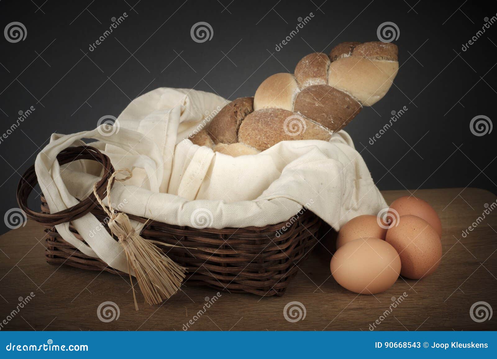 Braided Bread in a Wicker Basket and Eggs on the Table Stock Image ...