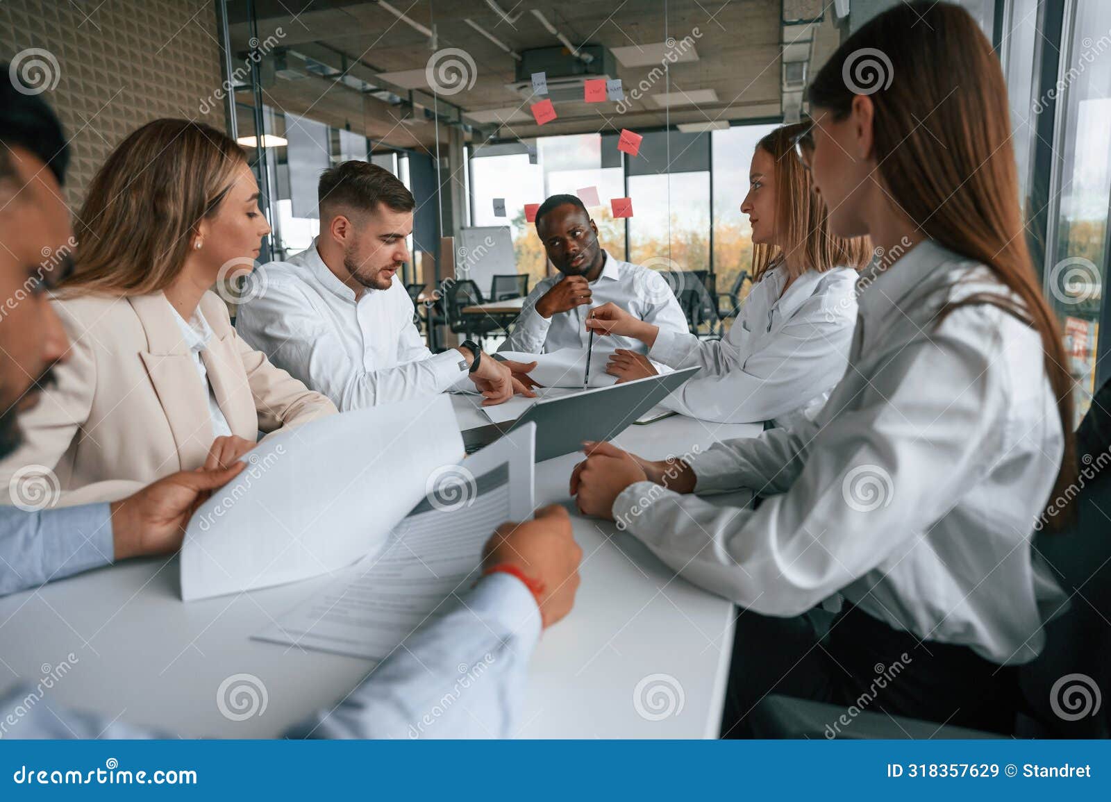 Brainstorming, Holding Documents, Thinking. Group of Office Workers are ...
