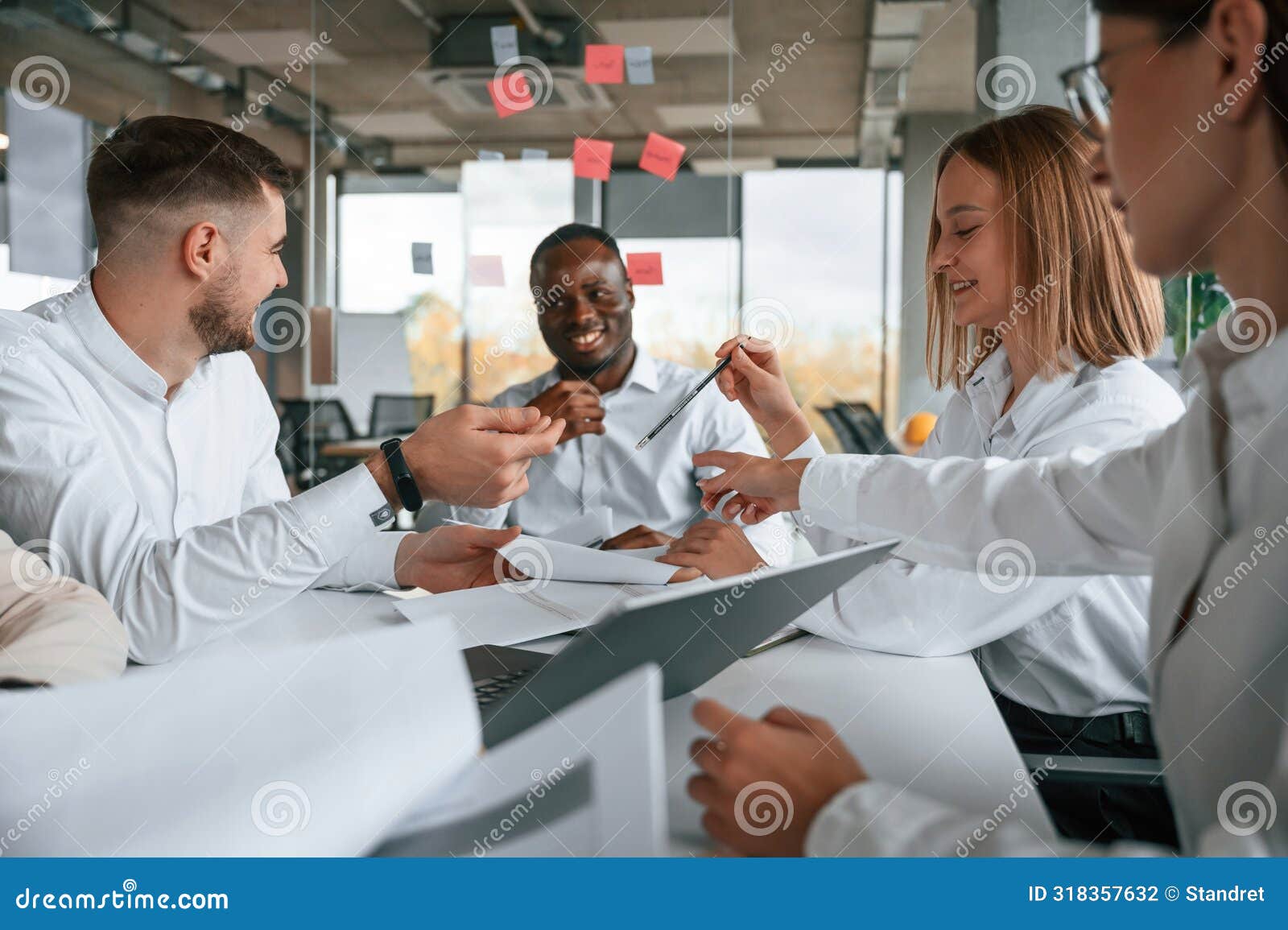 Brainstorming, Holding Documents, Thinking. Group of Office Workers are ...