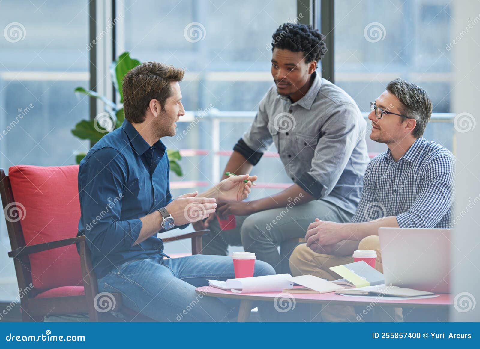 Brainstorming Trifecta. a Group of Office Workers Talking Together in a ...