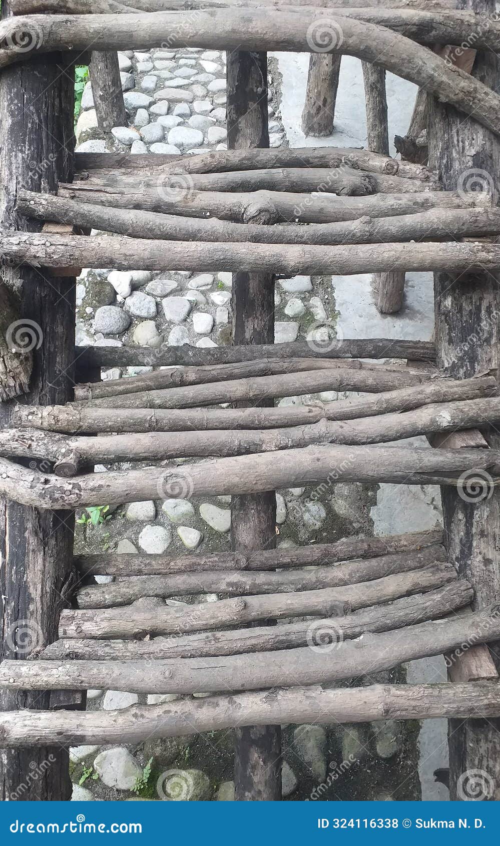 Branches Arranged Like a Ladder with Stone Structure Behind Stock Photo ...