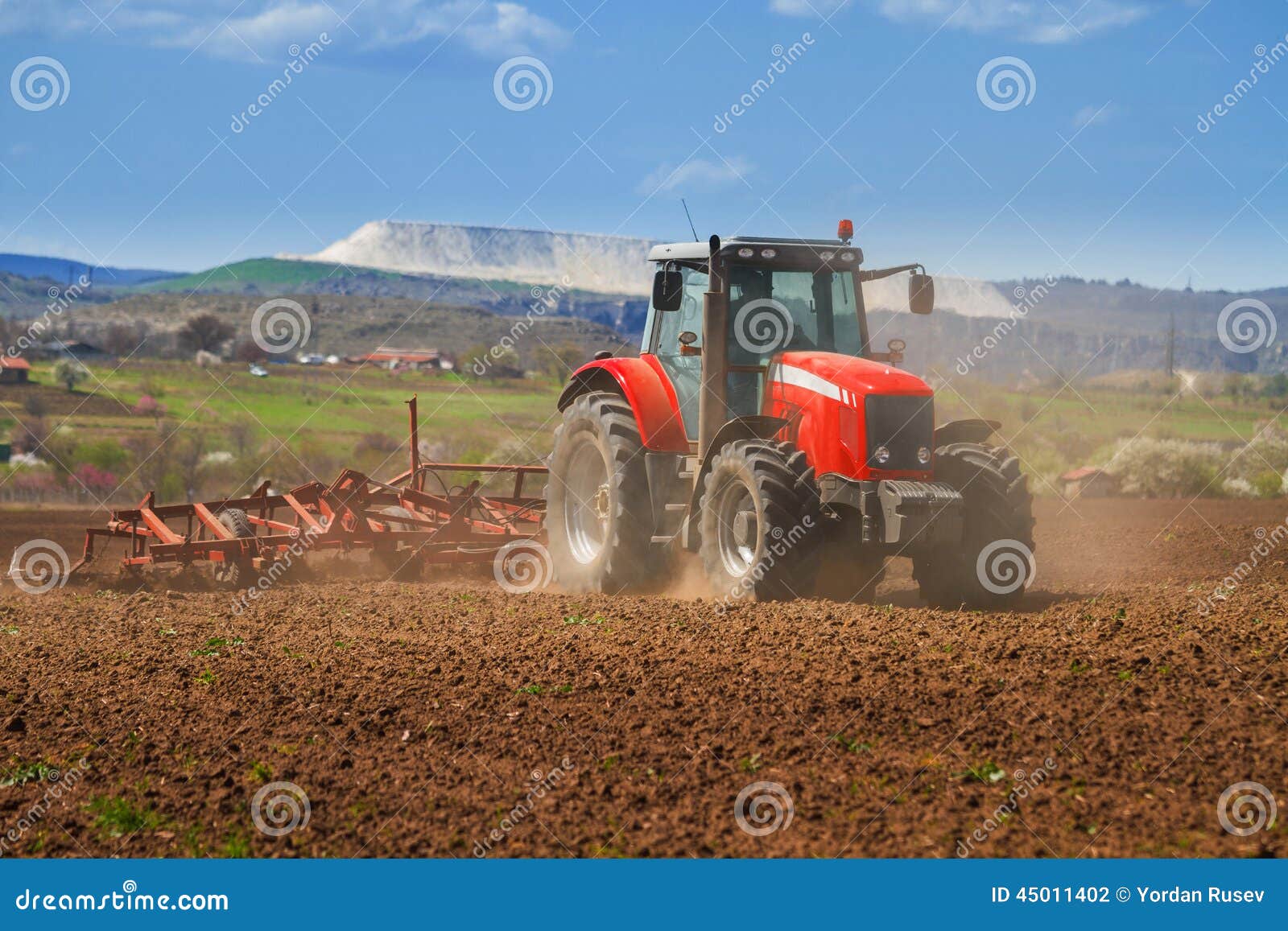Brand New Red Tractor Plowing the Land Stock Photo - Image of machinery ...