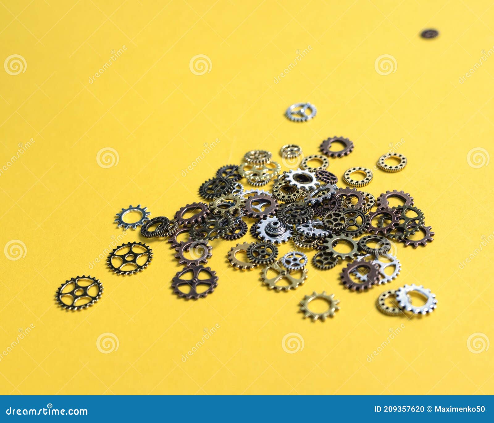 Brass Cog Wheels of Different Sizes Lying on Yellow Background Stock ...