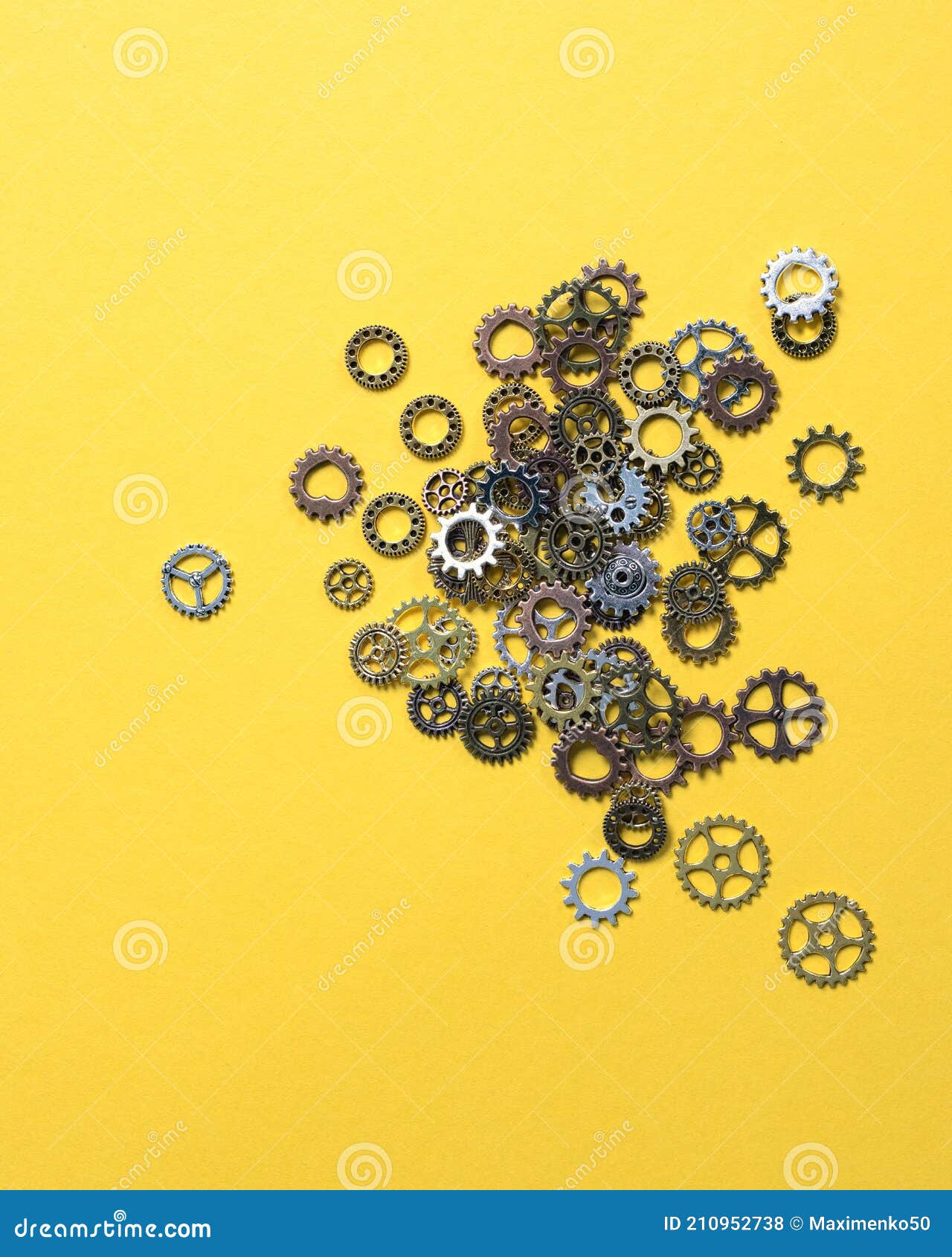Brass Cog Wheels of Different Sizes Lying on Yellow Background, Top ...