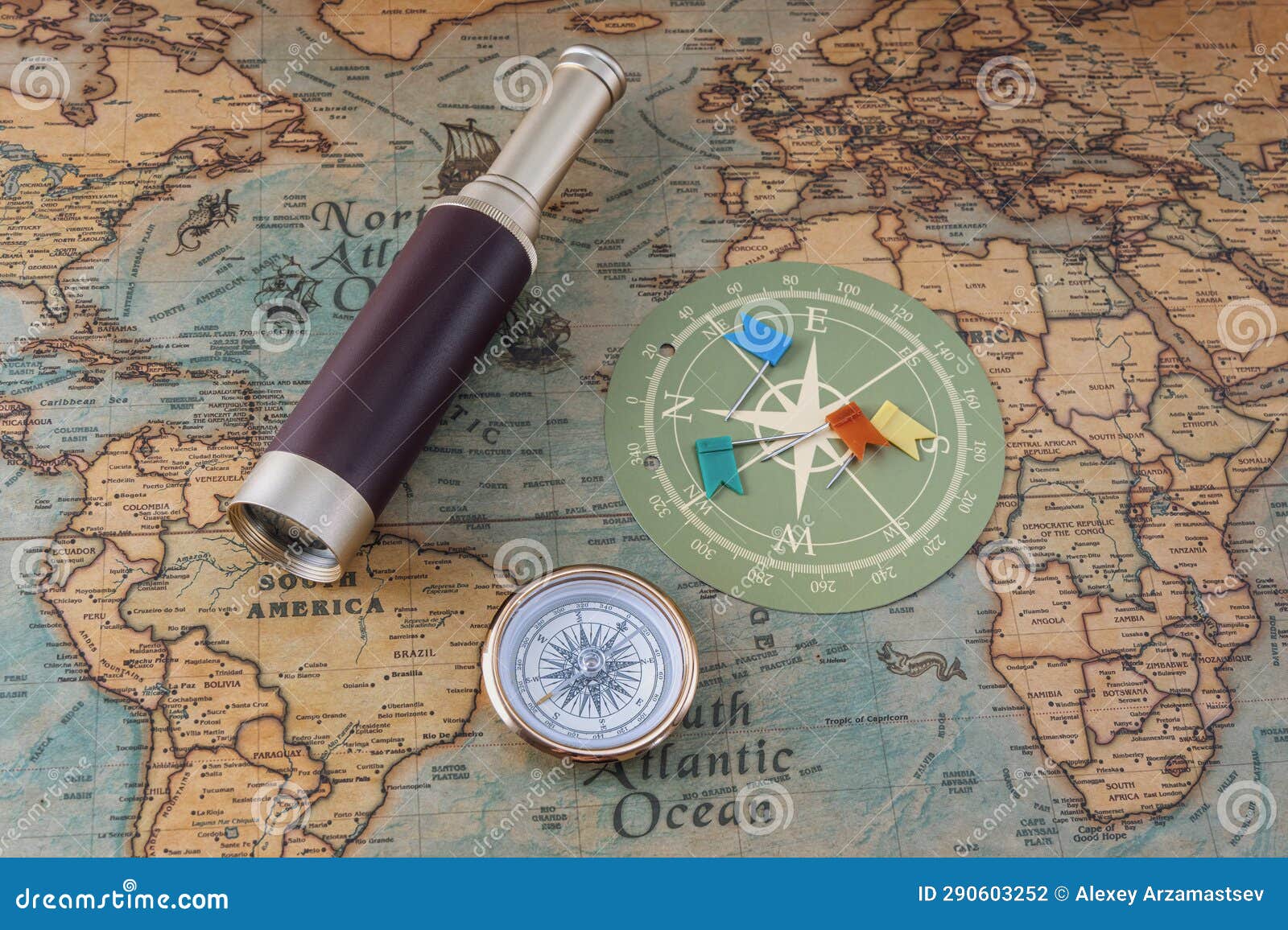 Brass Compass, a Spyglass and Multi-colored Markers Lie on an Old Map ...