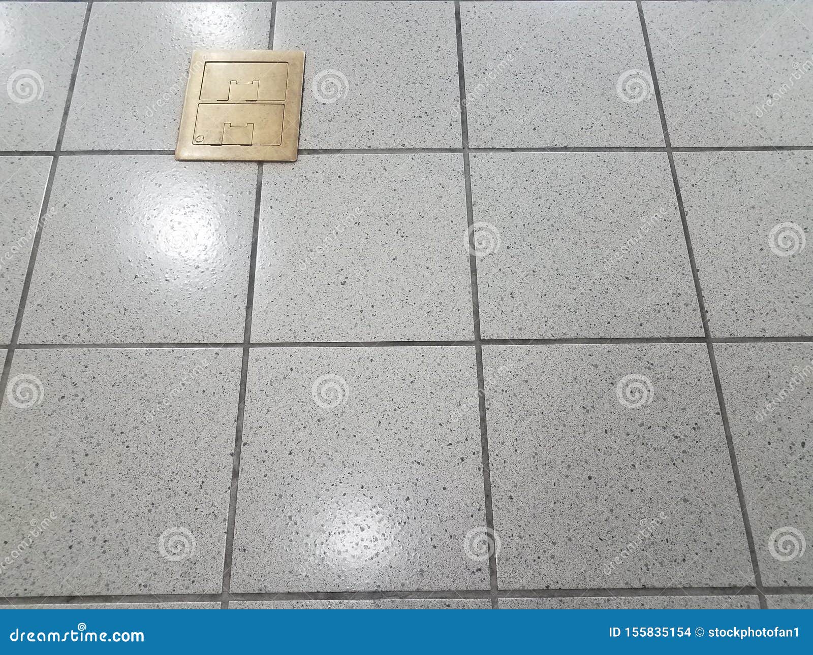 Brass Metal Electrical Outlets on Grey Tile Floor Stock Photo - Image ...