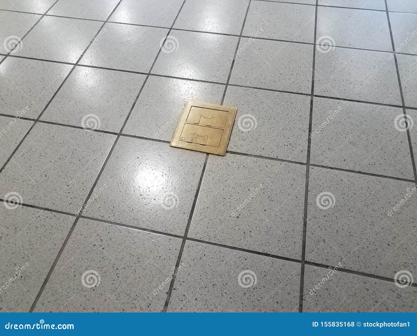 Brass Metal Electrical Outlets on Grey Tile Floor Stock Photo - Image ...