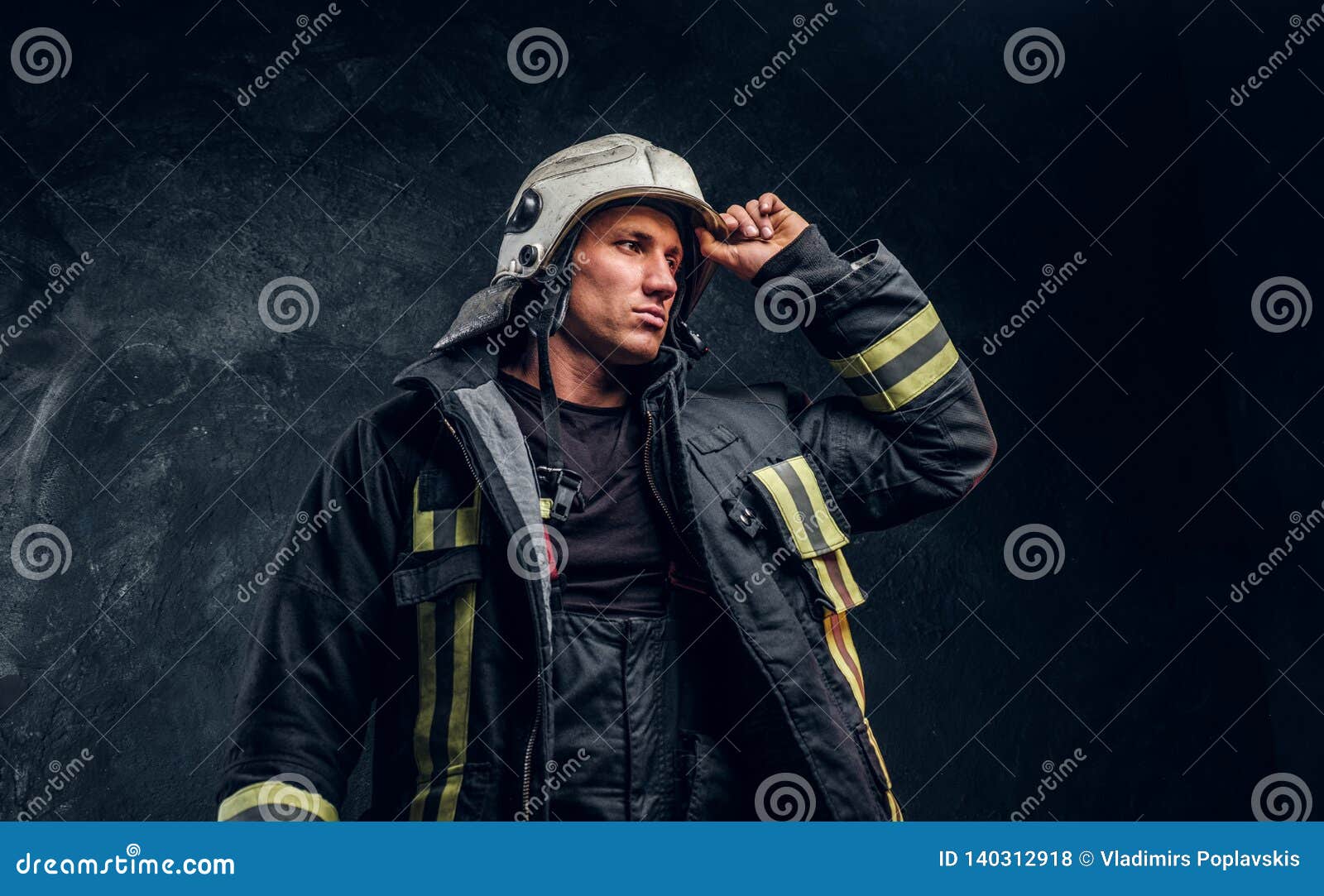 Brave Fireman in a Fire Suit Looking Sideways and Correcting the Helmet ...