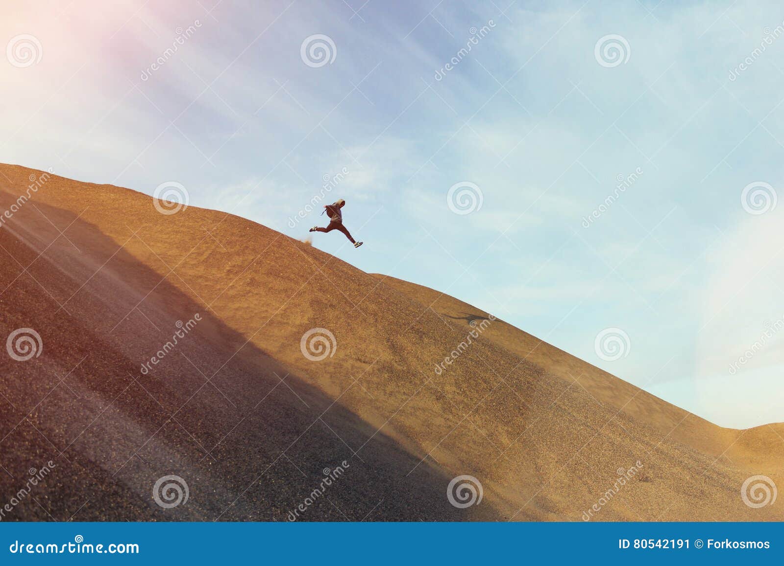 Brave Man with Backpack Running and Jumping on a Dune Stock Image ...