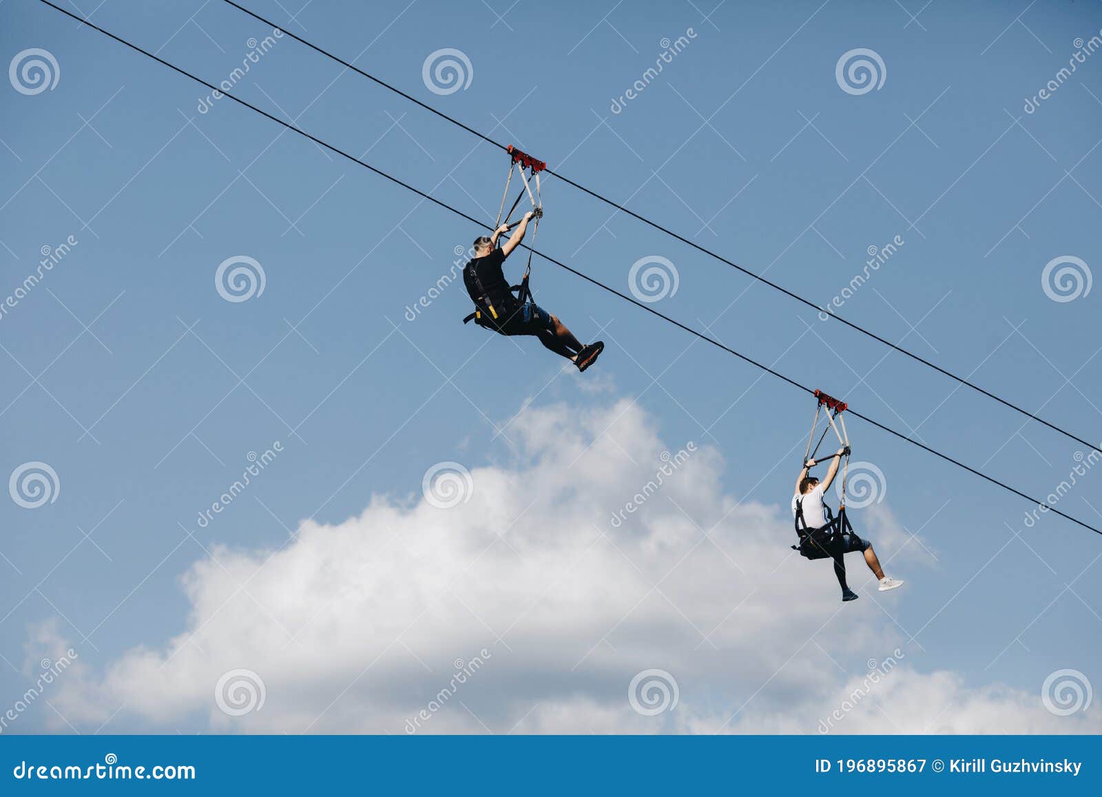 A Brave Man Descends on a Zip Line High in the Mountains Above the ...