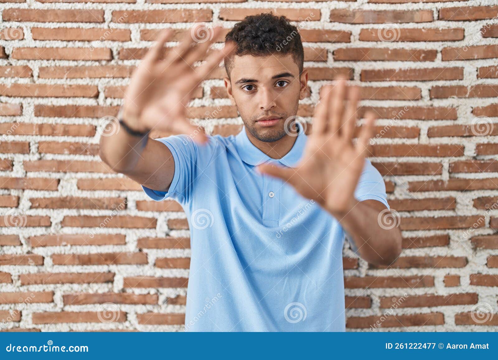 Brazilian Young Man Standing Over Brick Wall Doing Frame Using Hands ...