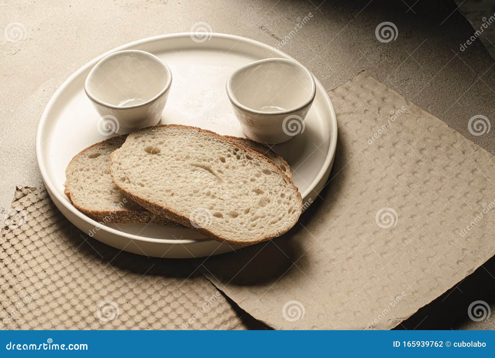 Bread on an empty plate stock photo. Image of bowl, fork - 165939762