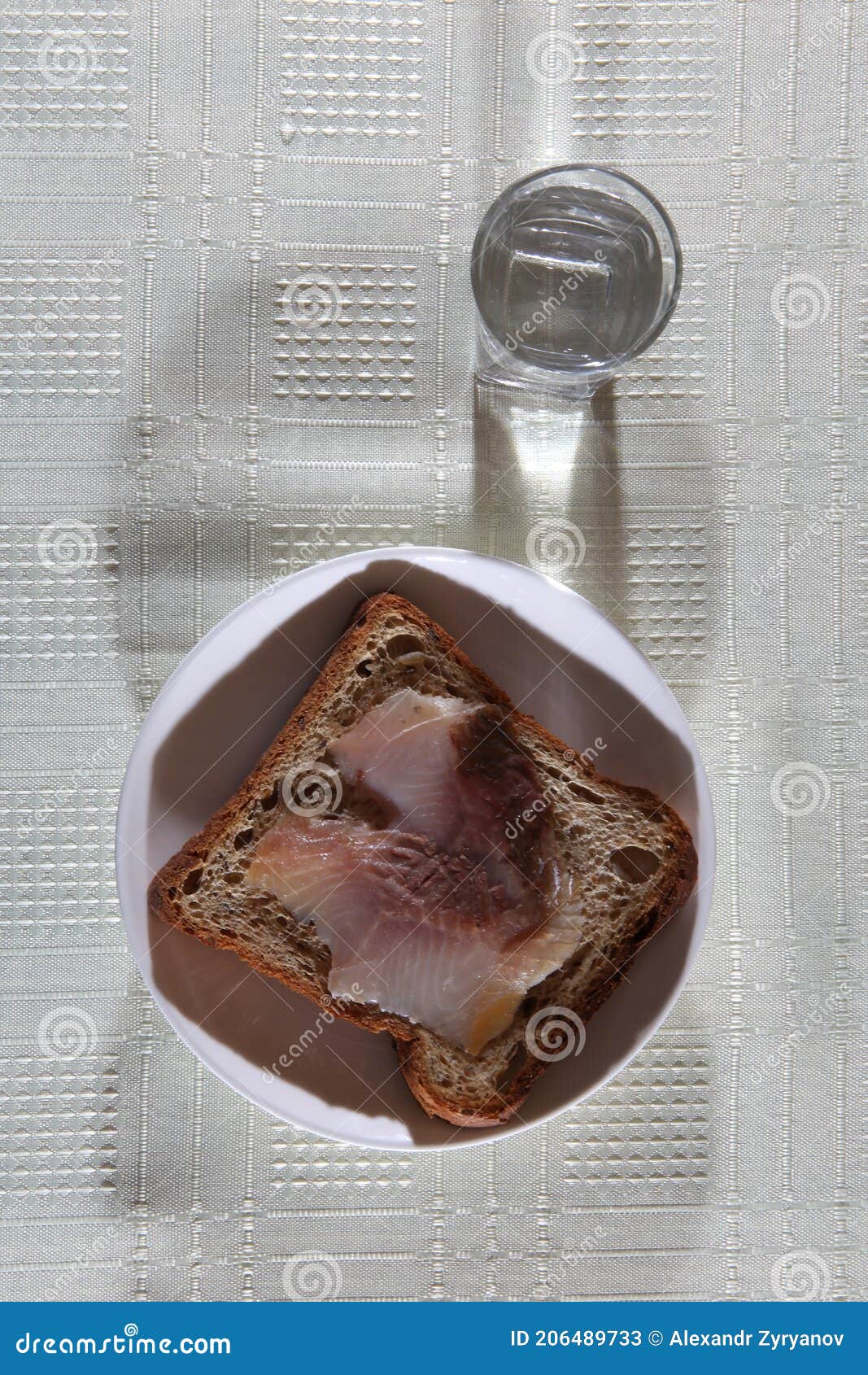 Bread, Salted Fish and Alcohol on a White Tablecloth Stock Image ...