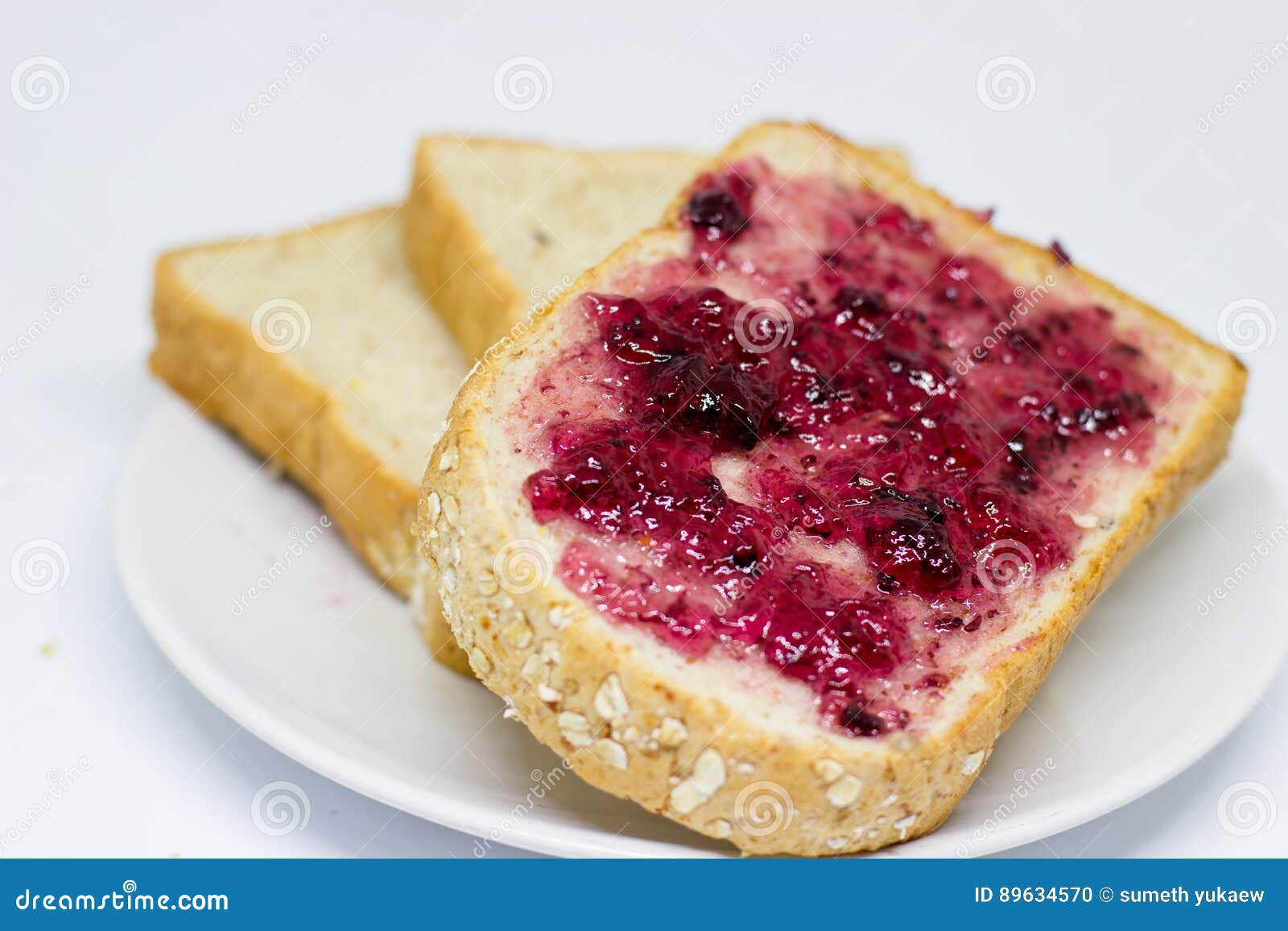 Bread With Spread Jam On The Dish On White Isolate Background Stock ...
