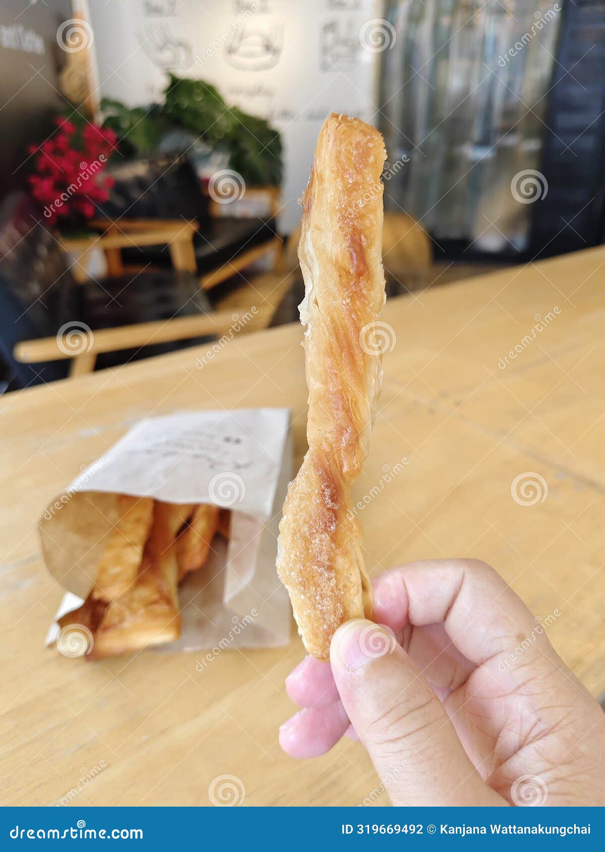 A bread stick in hand. stock photo. Image of finger - 319669492
