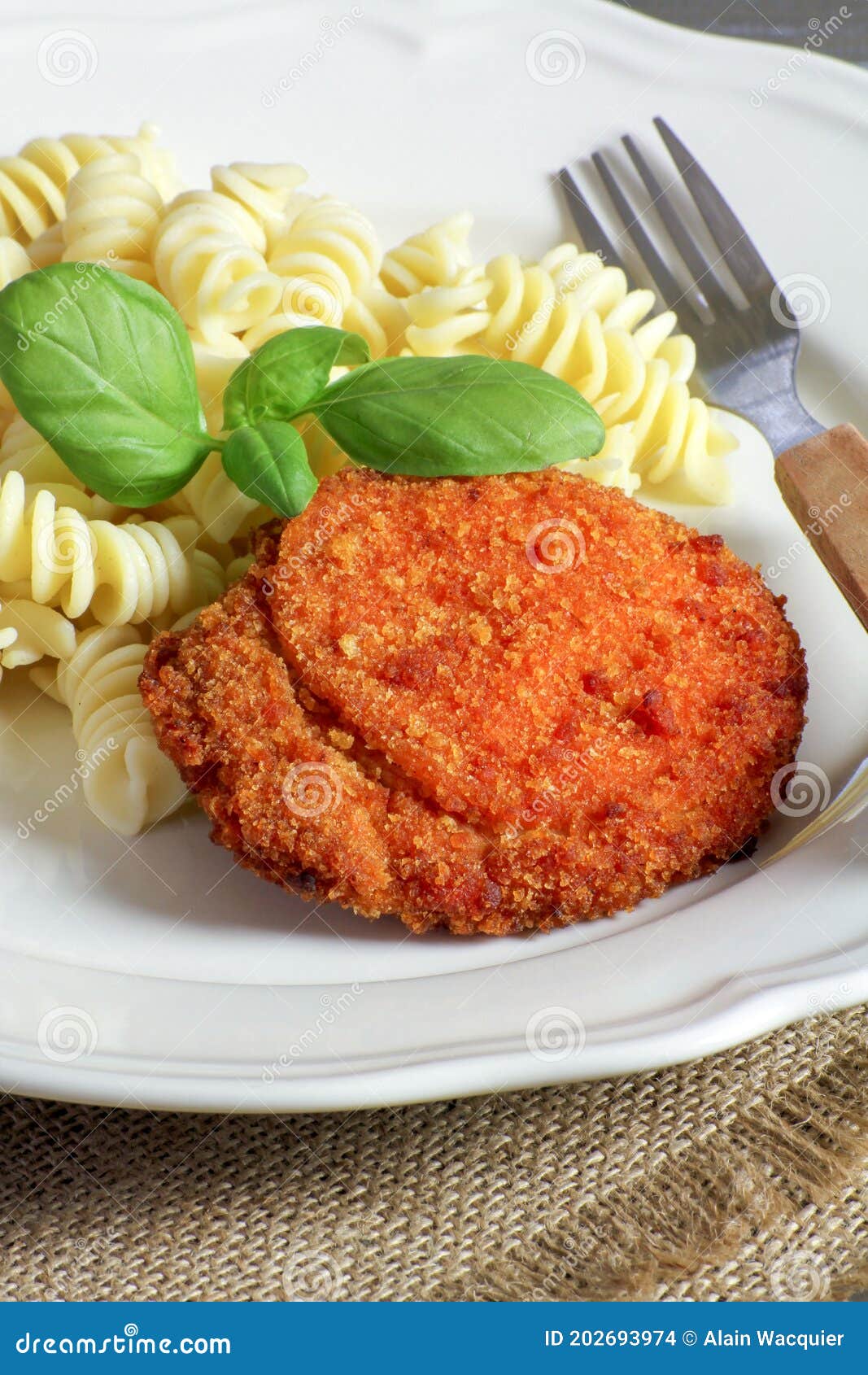 Breaded escalope and pasta stock photo. Image of basil - 202693974