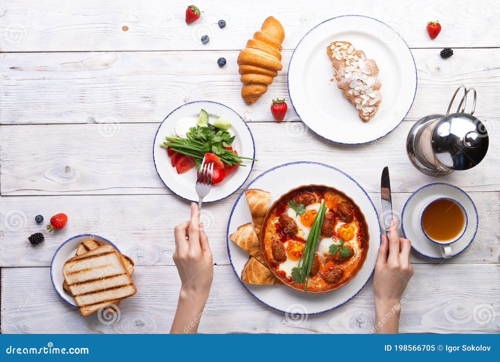 Breakfast is Served on a Light Board. Fried Eggs, Omelet, Croissant ...