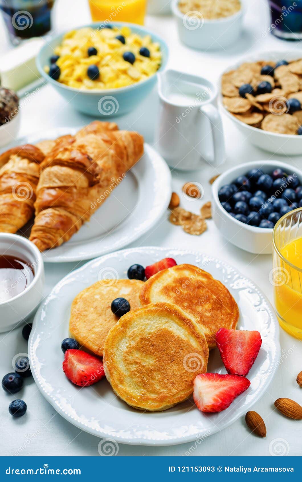 Breakfast Table Setting with Flakes, Juice, Croissants, Pancakes Stock ...