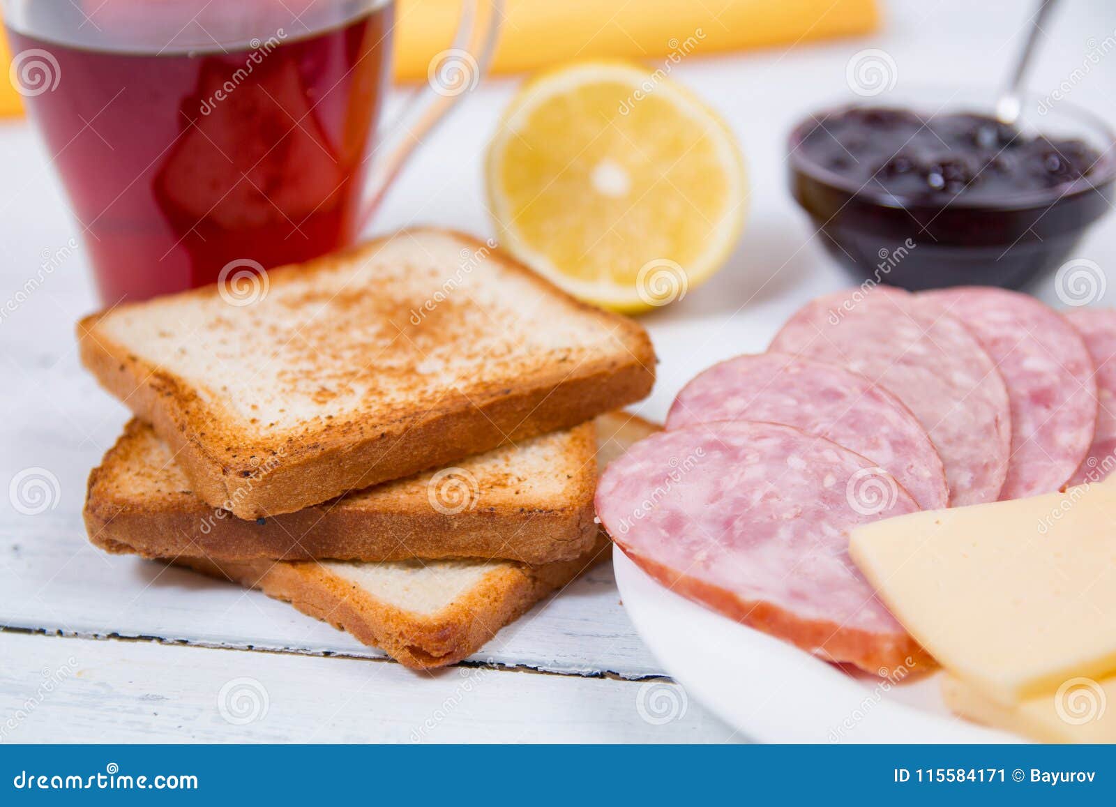 Breakfast with Tea, Toasts, Lemon, Jam, Cheese and Salami Stock Image ...
