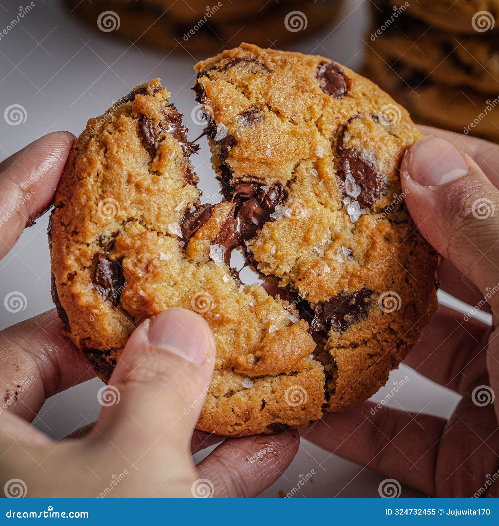 Breaking a Chocolate Chip Cookie in Half. Stock Image - Image of ...
