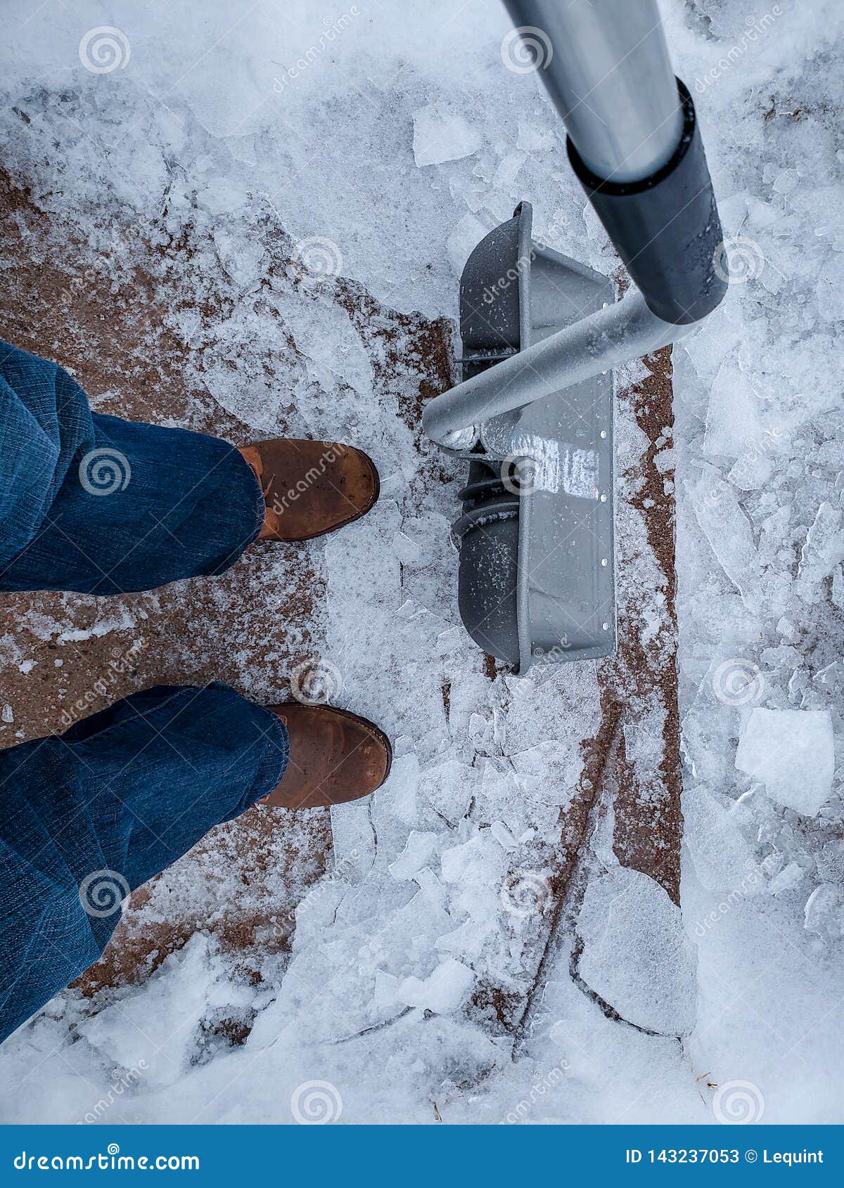 Breaking through Ice on Sidewalk with Shovel during Cold Weather Stock ...