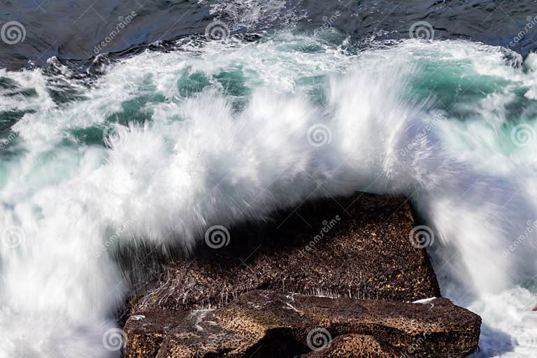 Breaking wave on rock stock image. Image of rock, wash - 215556793