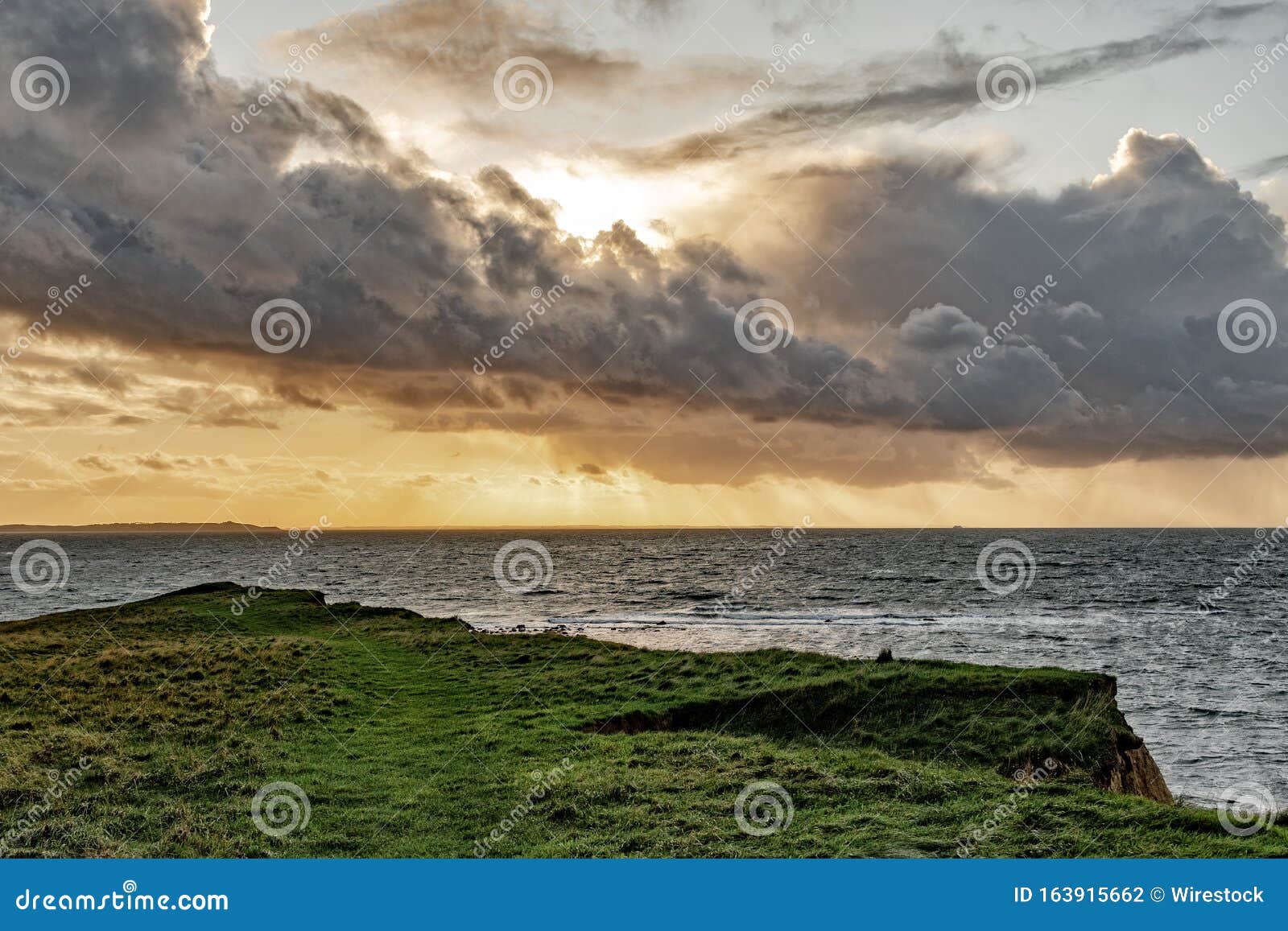 Breathtaking View of a Grass Covered Cliff Over the Ocean Under the ...