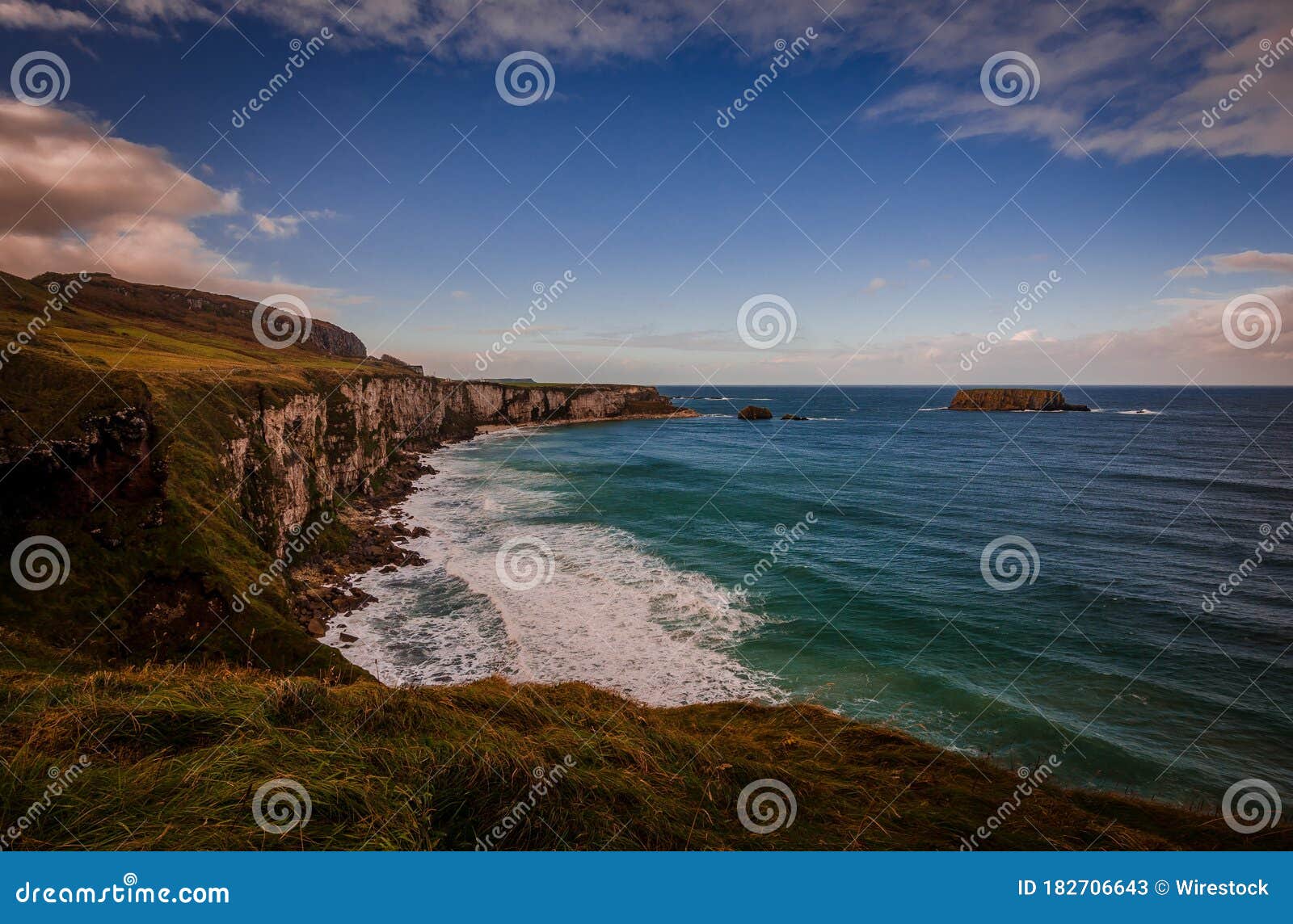 Breathtaking View of the Grass-covered Cliffs by the Ocean Under the ...