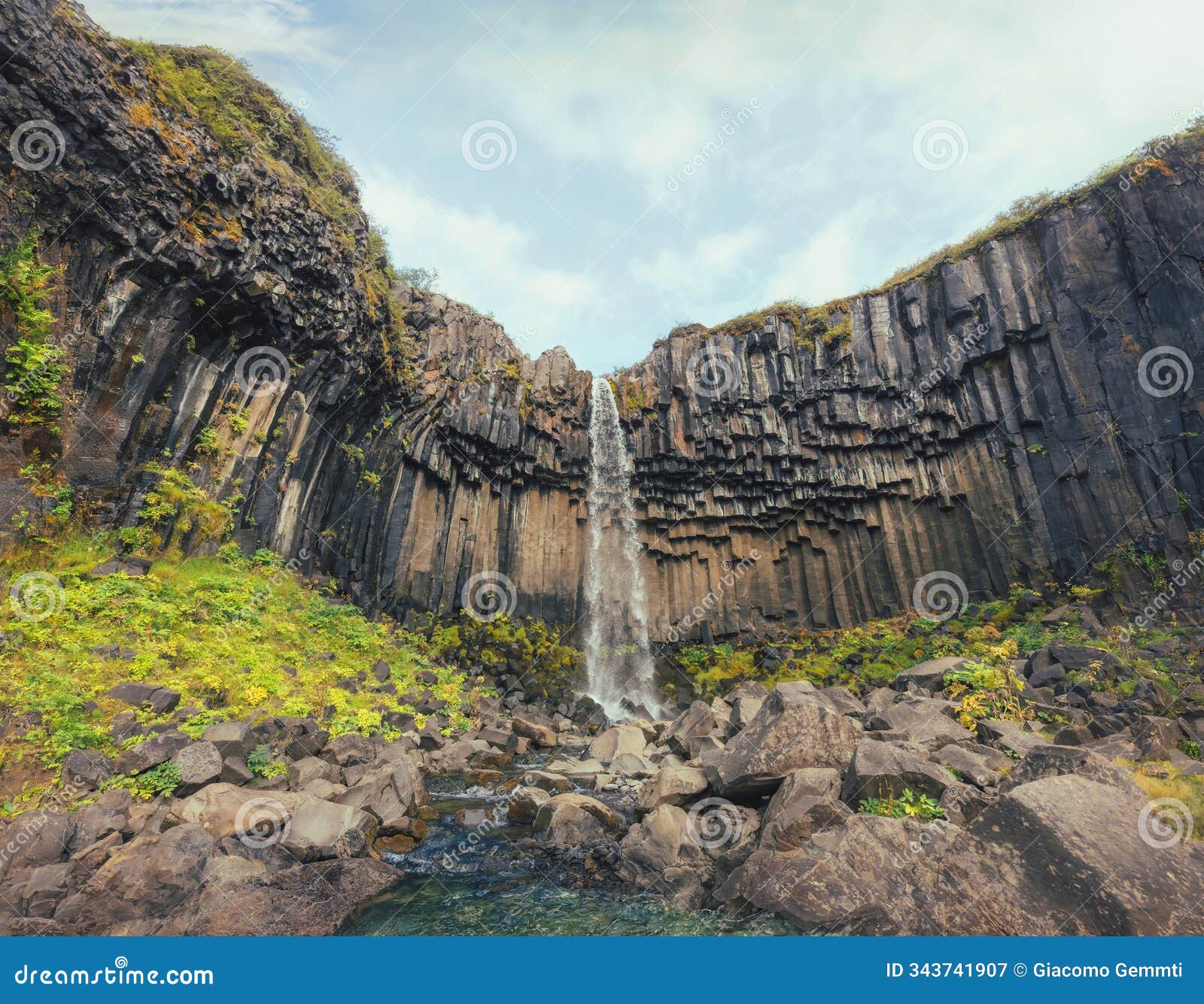 A Breathtaking View of a Tall Waterfall Cascading Down a Dramatic Cliff ...