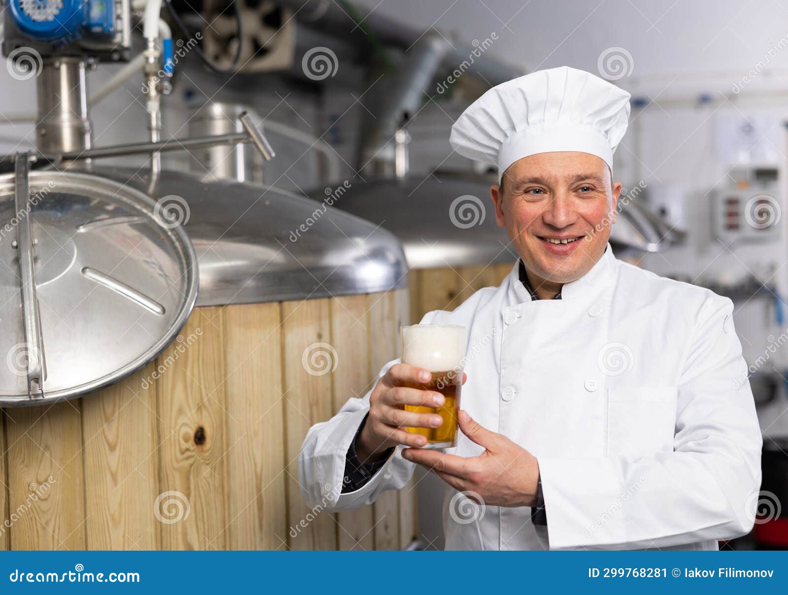 Brewer is Standing with Beer with Foam in Glass on His Workplace Stock ...
