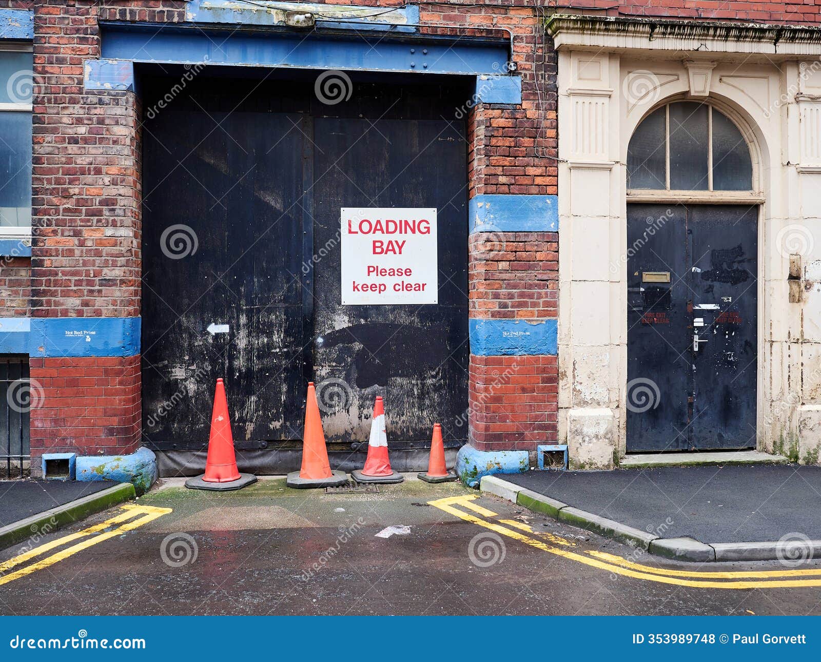 Brick Building with Loading Bay Sign and Safety Cones Stock Photo ...