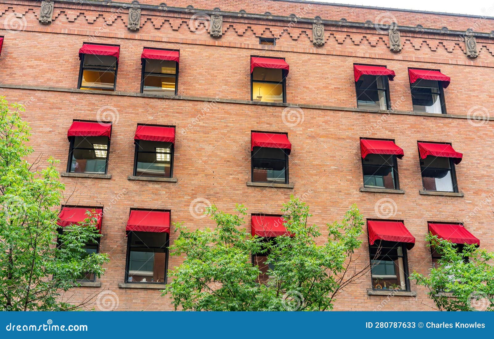 Brick Building with Red Shades Over Windows Stock Image - Image of ...