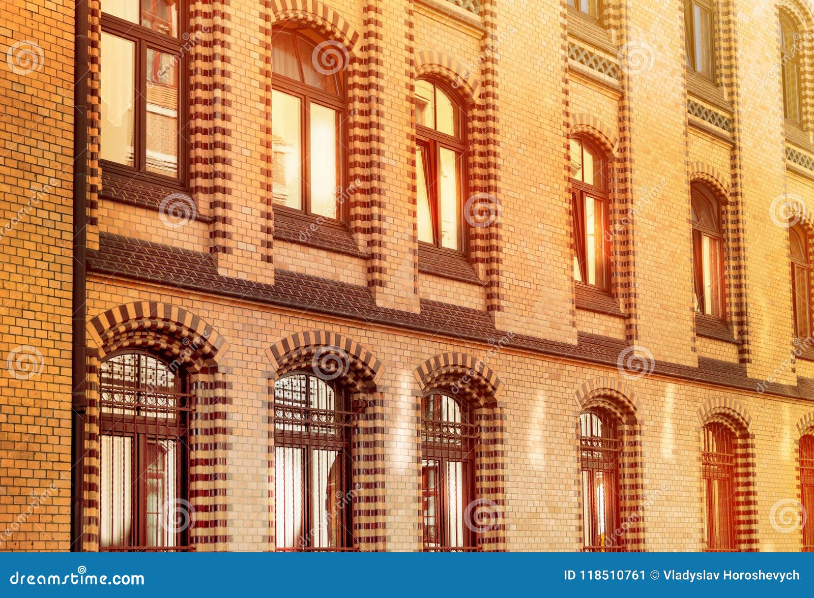 A Brick Building with Shiny Windows at Sunset, Beautiful Sunlight ...