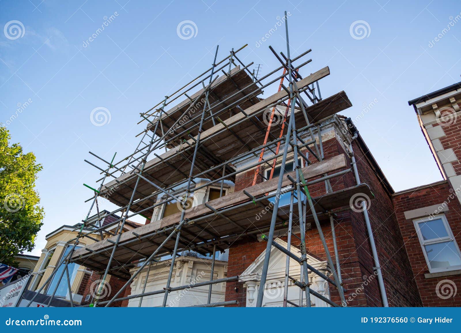 A Brick Building Surrounded by Scaffolding Poles Ready for Construction ...