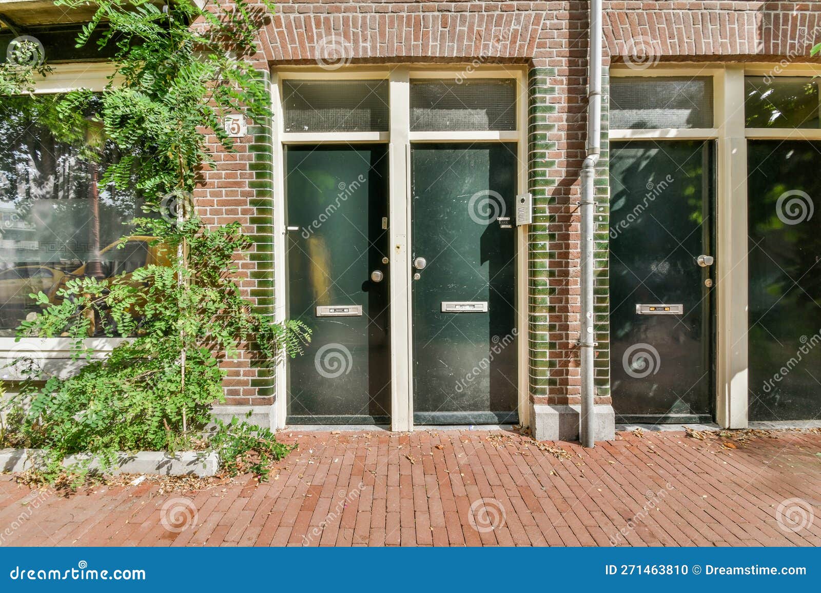 A Brick Building with Two Doors and a Brick Sidewalk Editorial Image ...