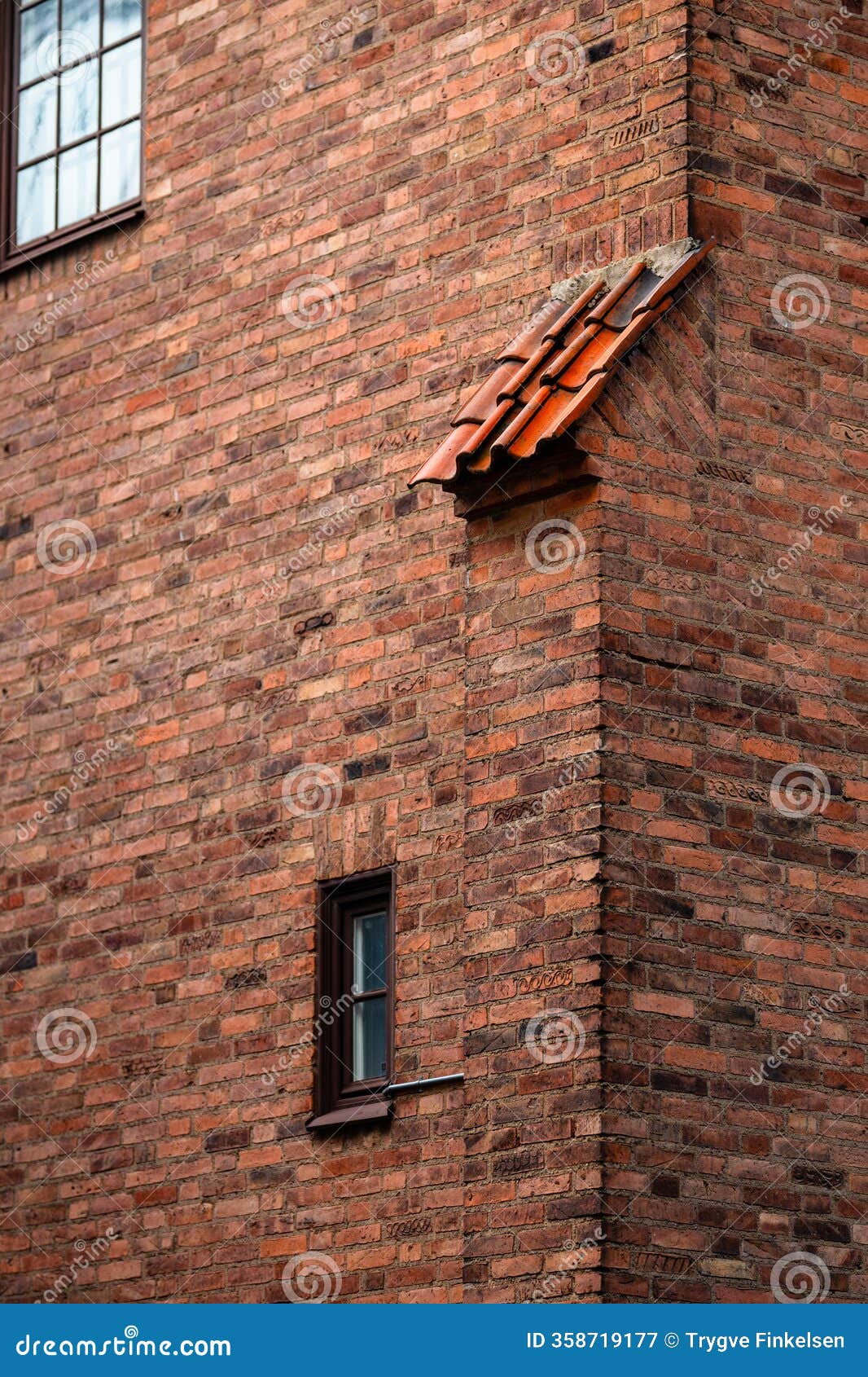 Brick Building with Two Windows and Small Roof Structure.. Stock Image ...