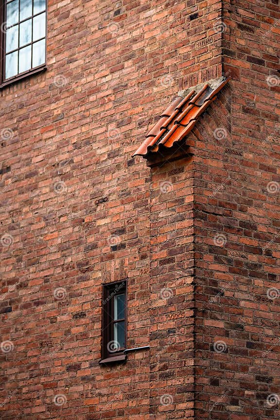 Brick Building with Two Windows and Small Roof Structure.. Stock Image ...