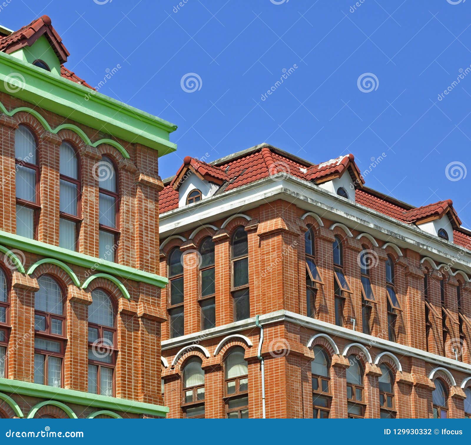 Brick Buildings Soaring into Blue Sky Stock Photo - Image of roof ...