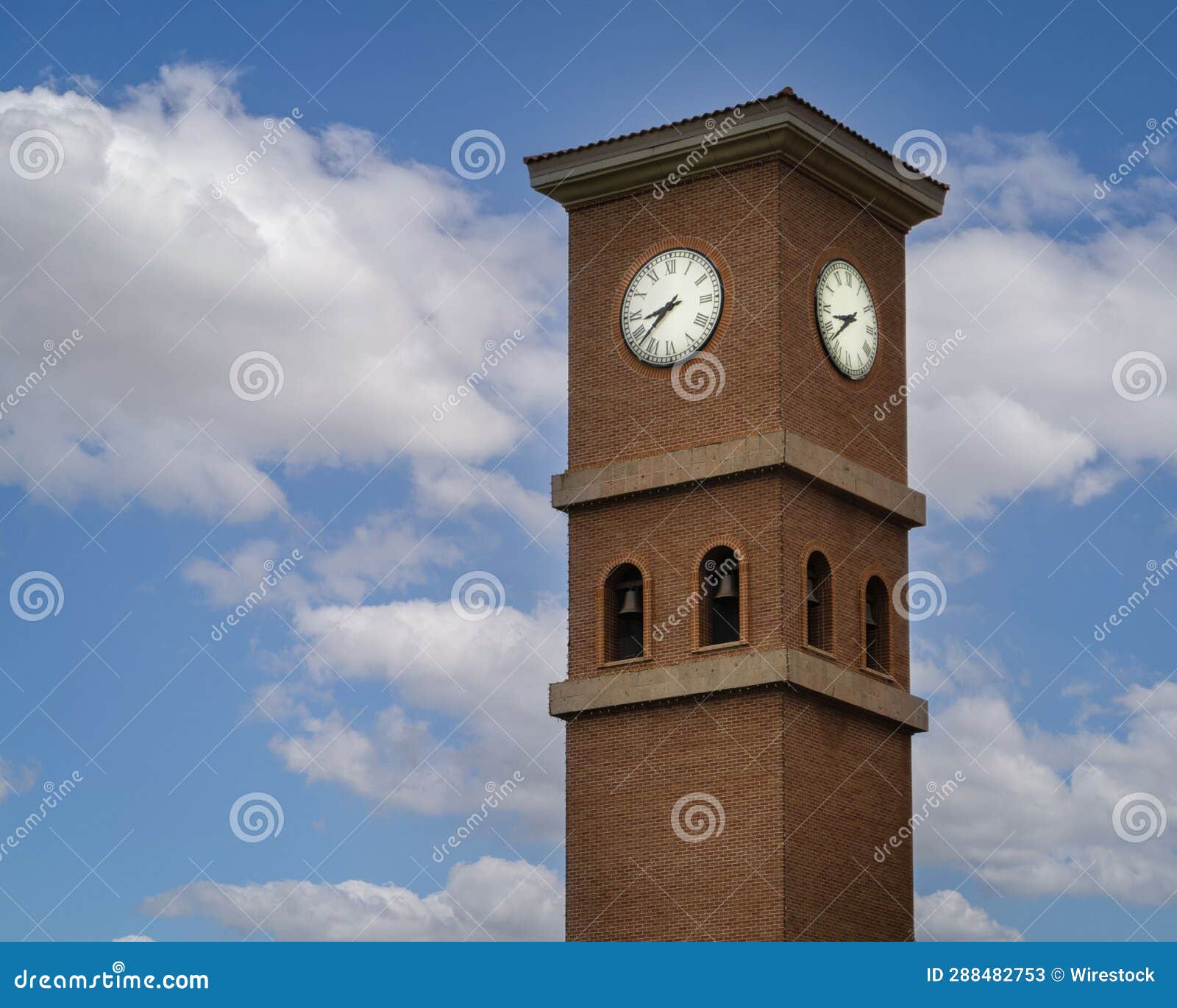 Brick Clock Tower Against a Cloudy Blue Sky Stock Image - Image of ...