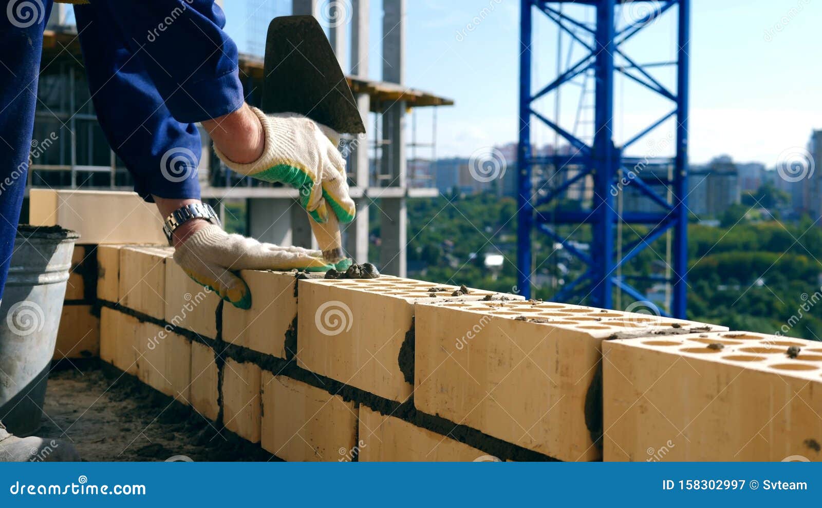A Brick is Getting Inserted and Leveled in the Building Wall Stock ...