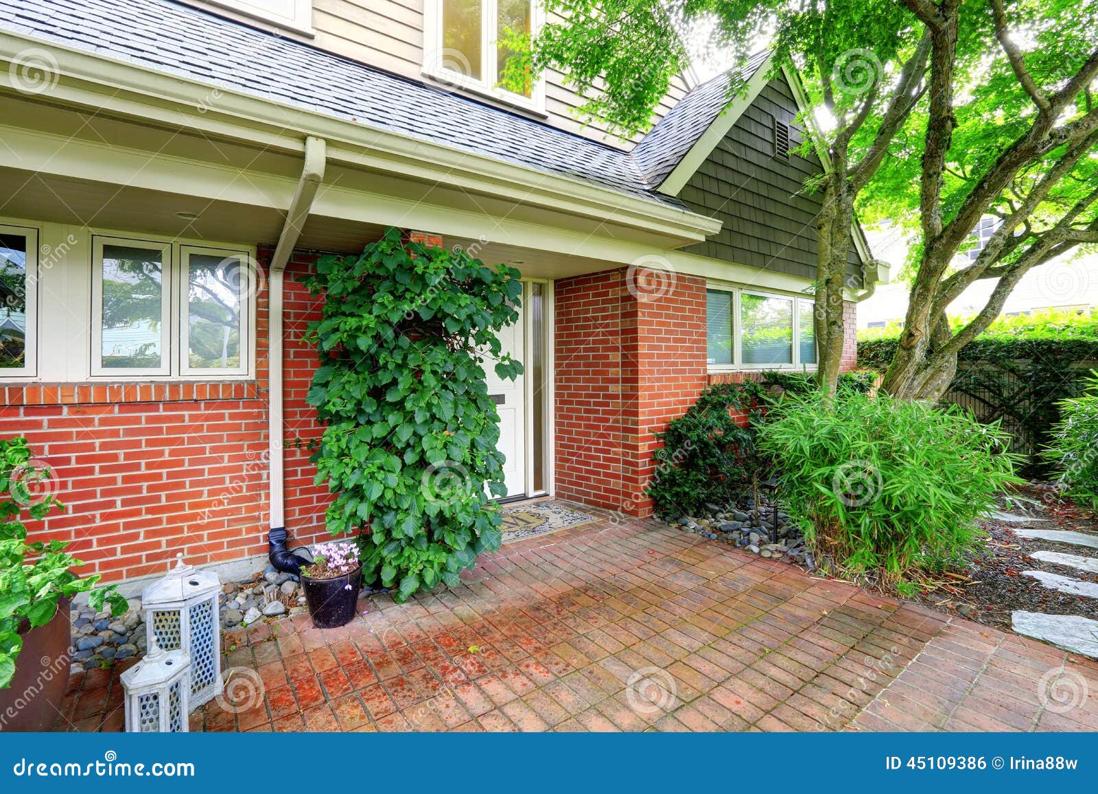 Brick House Exterior with Tile Floor Front Yard Stock Photo - Image of ...