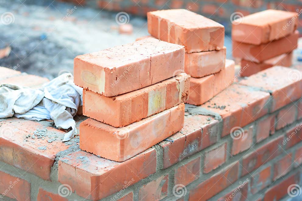 Brick House Wall Constuction with Stack of Red Bricks. Building House ...