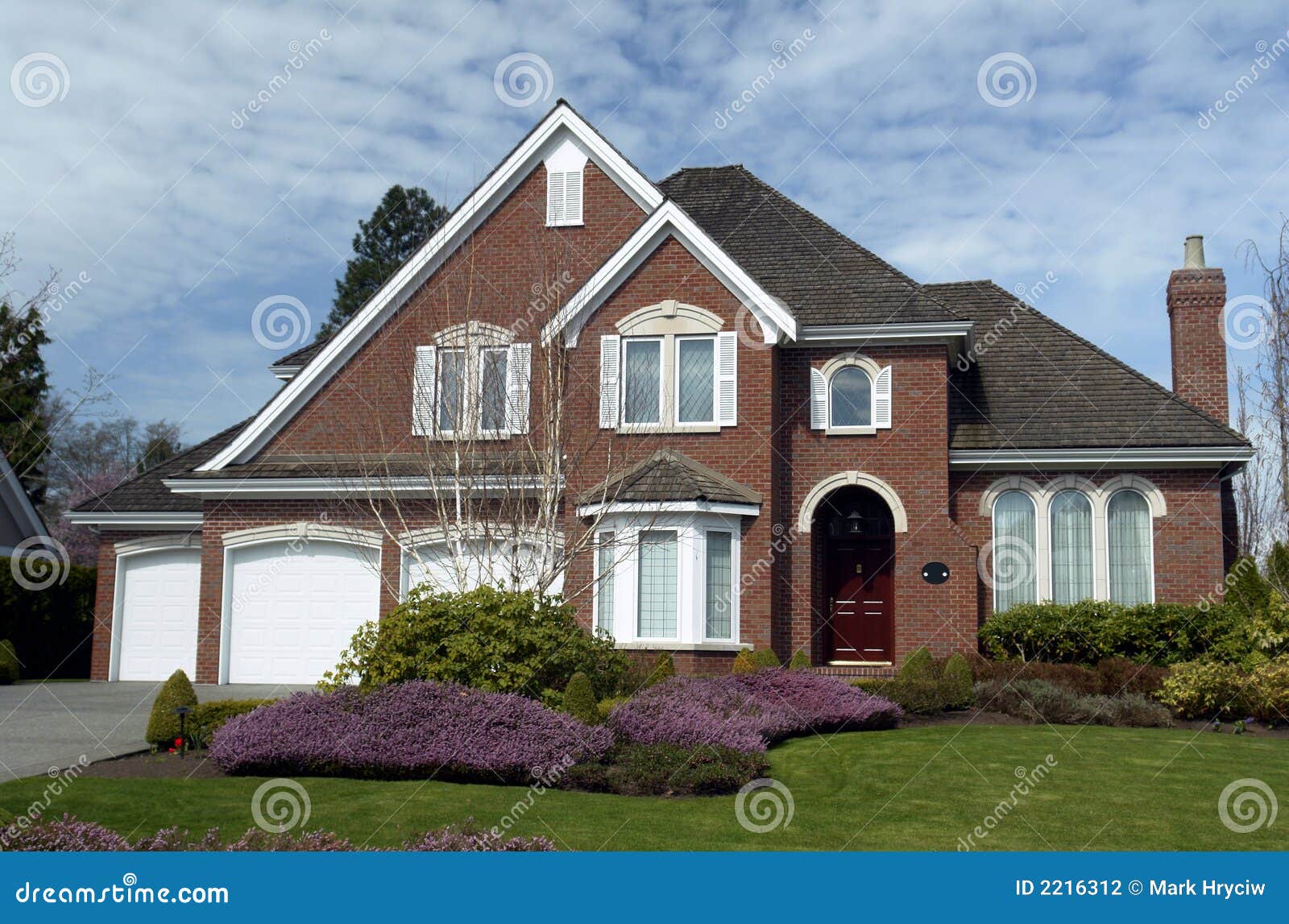 Brick Manor House With Topiary Front Yard Enclosed By Tree Trunks ...