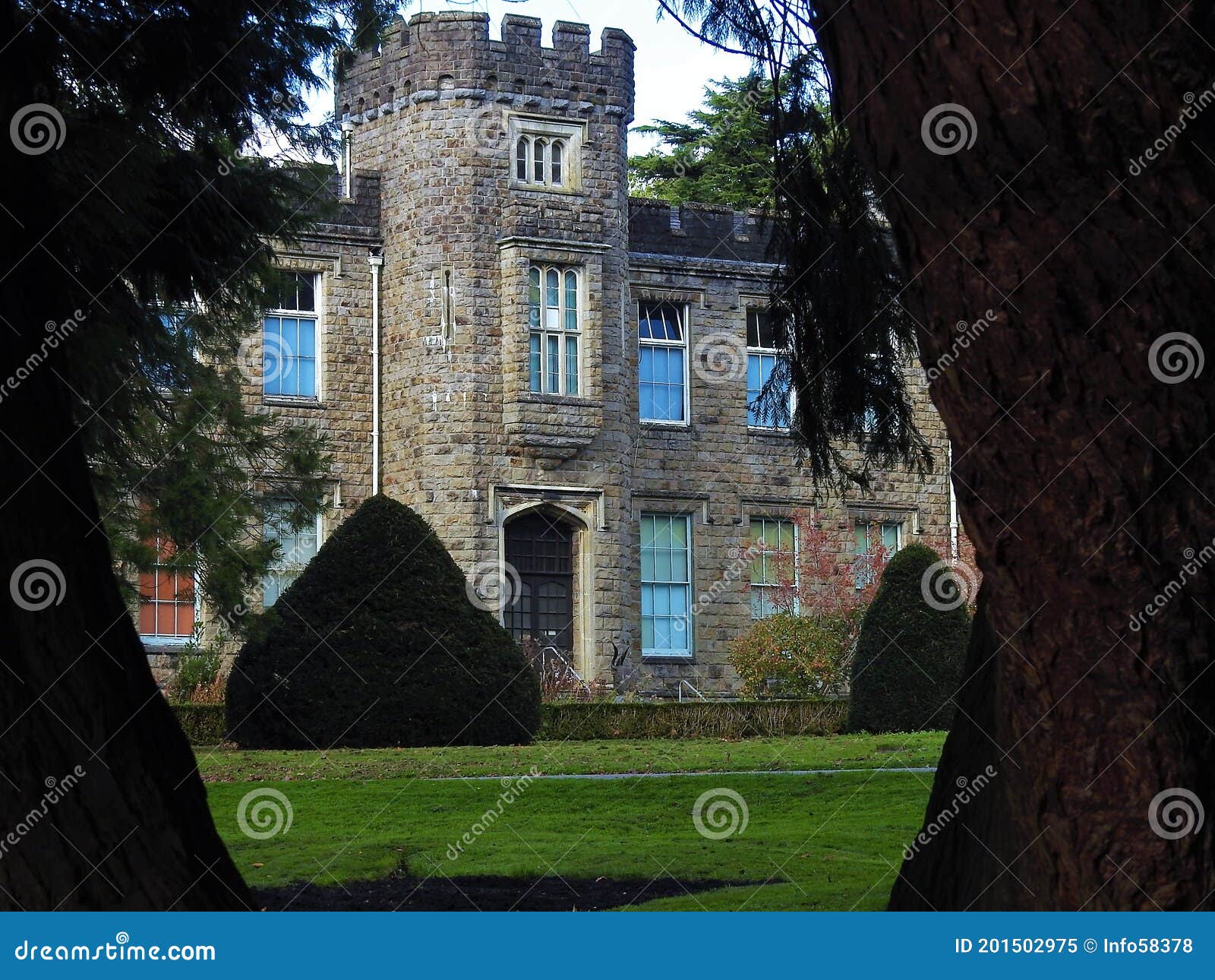Brick Manor House with Topiary Front Yard Enclosed by Tree Trunks ...