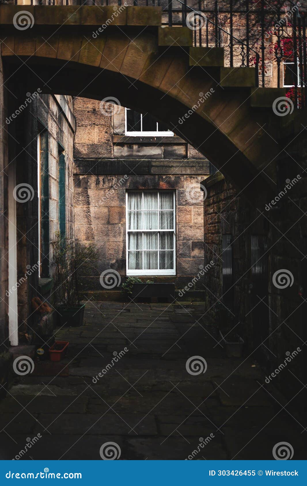 Brick Pathway Leads between Two Buildings, with Ornate Iron Railings in ...