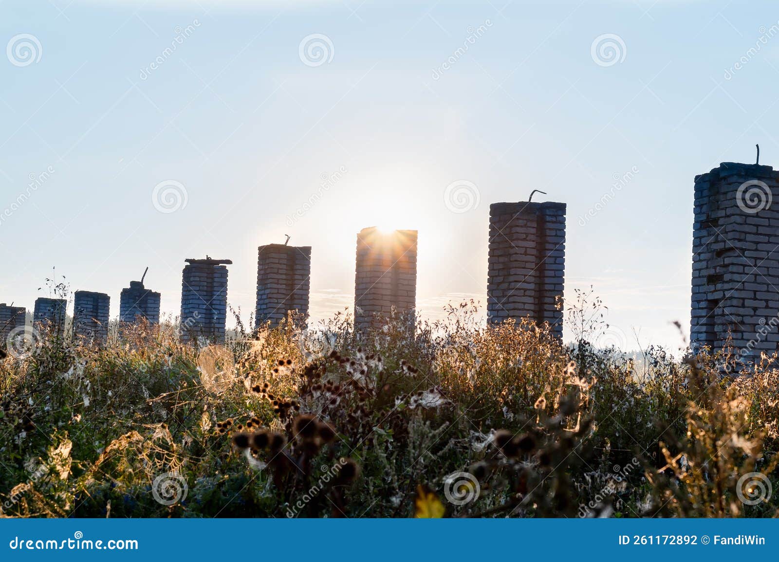 Brick Pillars in a Field from a Destroyed Building at Sunrise. Ruins of ...