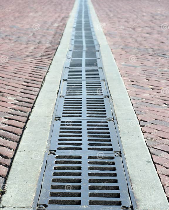 Brick road and grate stock photo. Image of outdoors, grate - 14583382