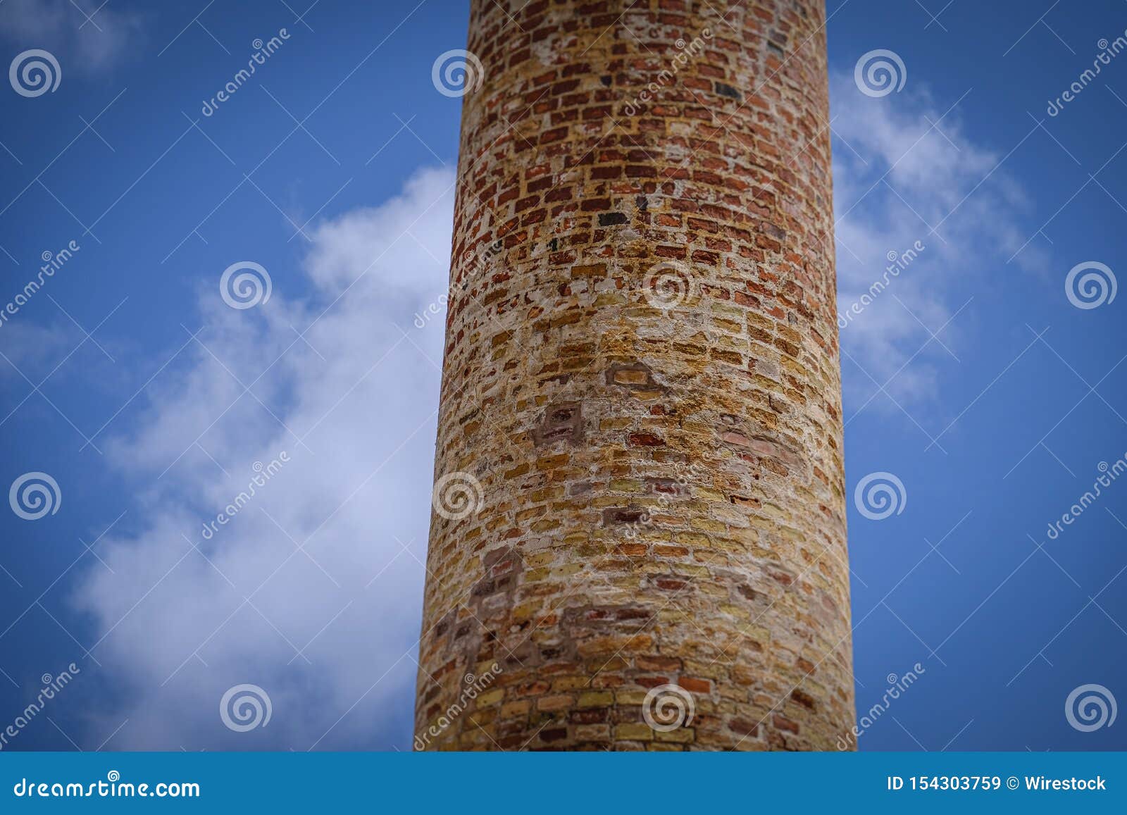Brick Tower with a Cloudy Sky in the Background Stock Image - Image of ...